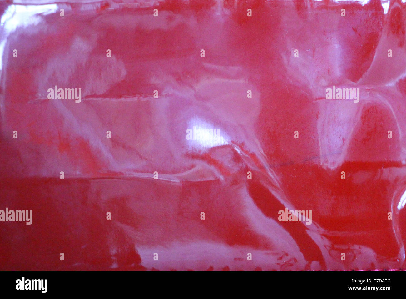 The texture of red oilcloth. Saturated red polyethylene, close-up ...