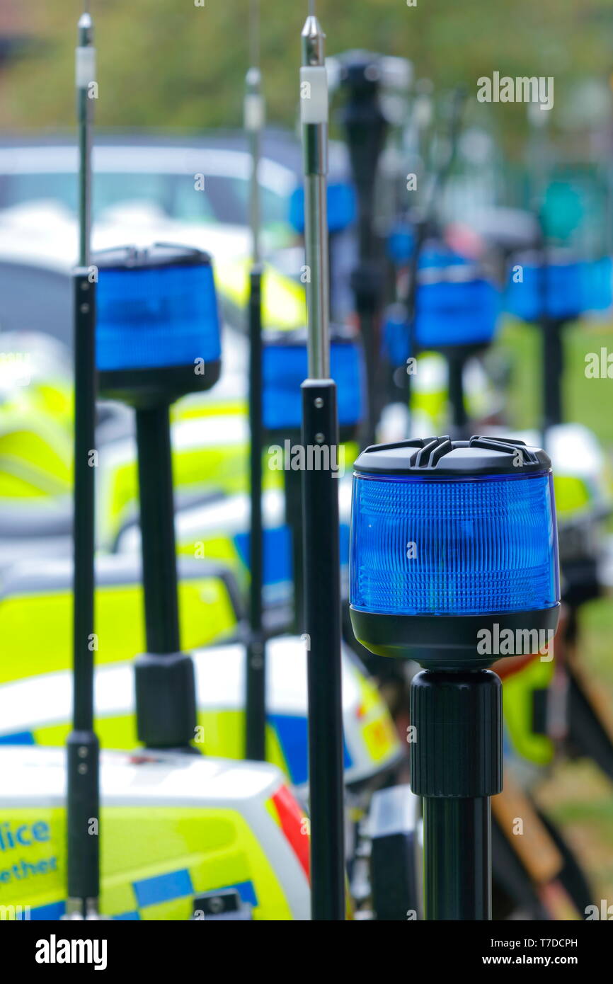 Abstract of blue lights from a convoy of parked police motorcycles ...