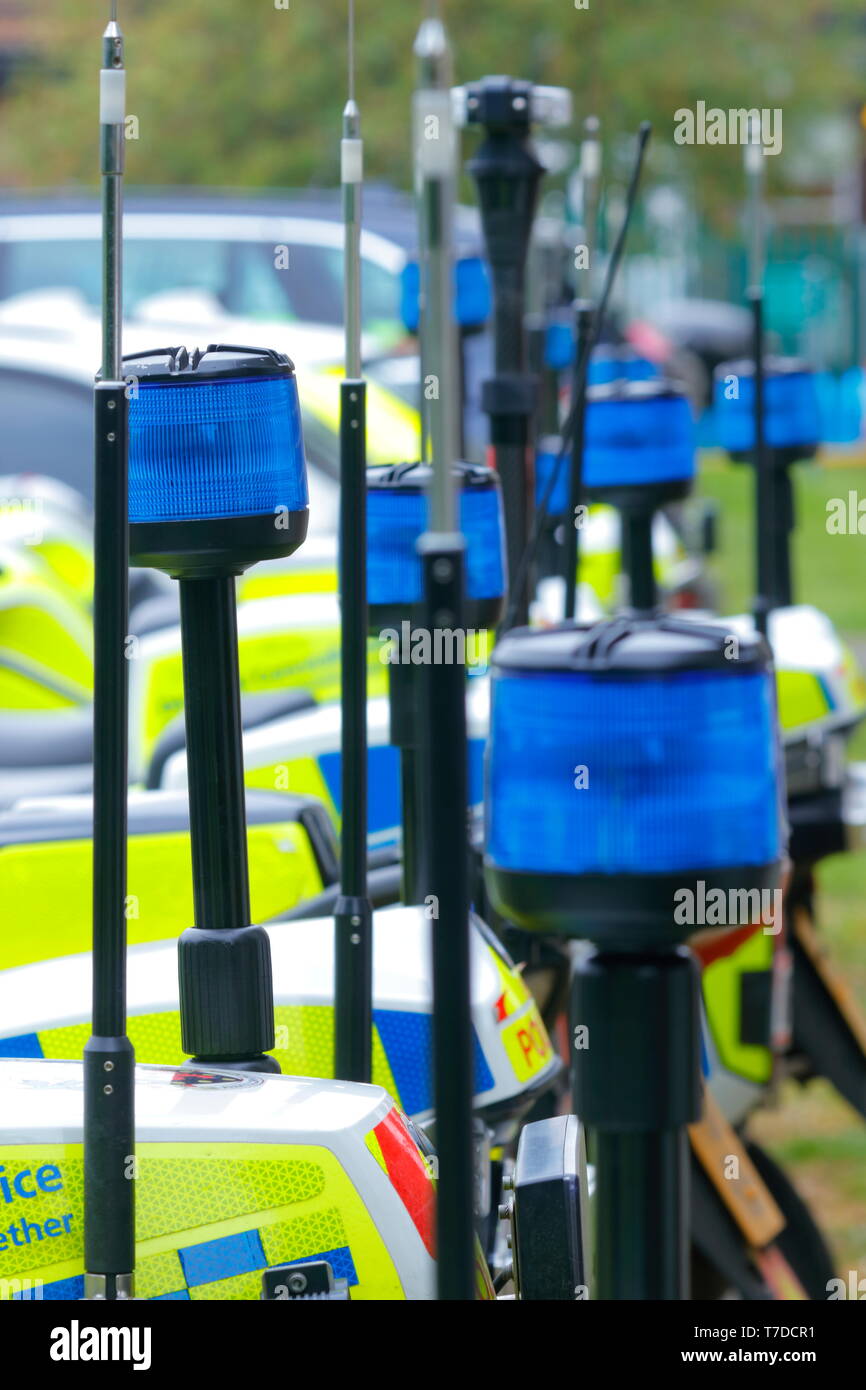 Abstract of blue lights from a convoy of parked police motorcycles ...