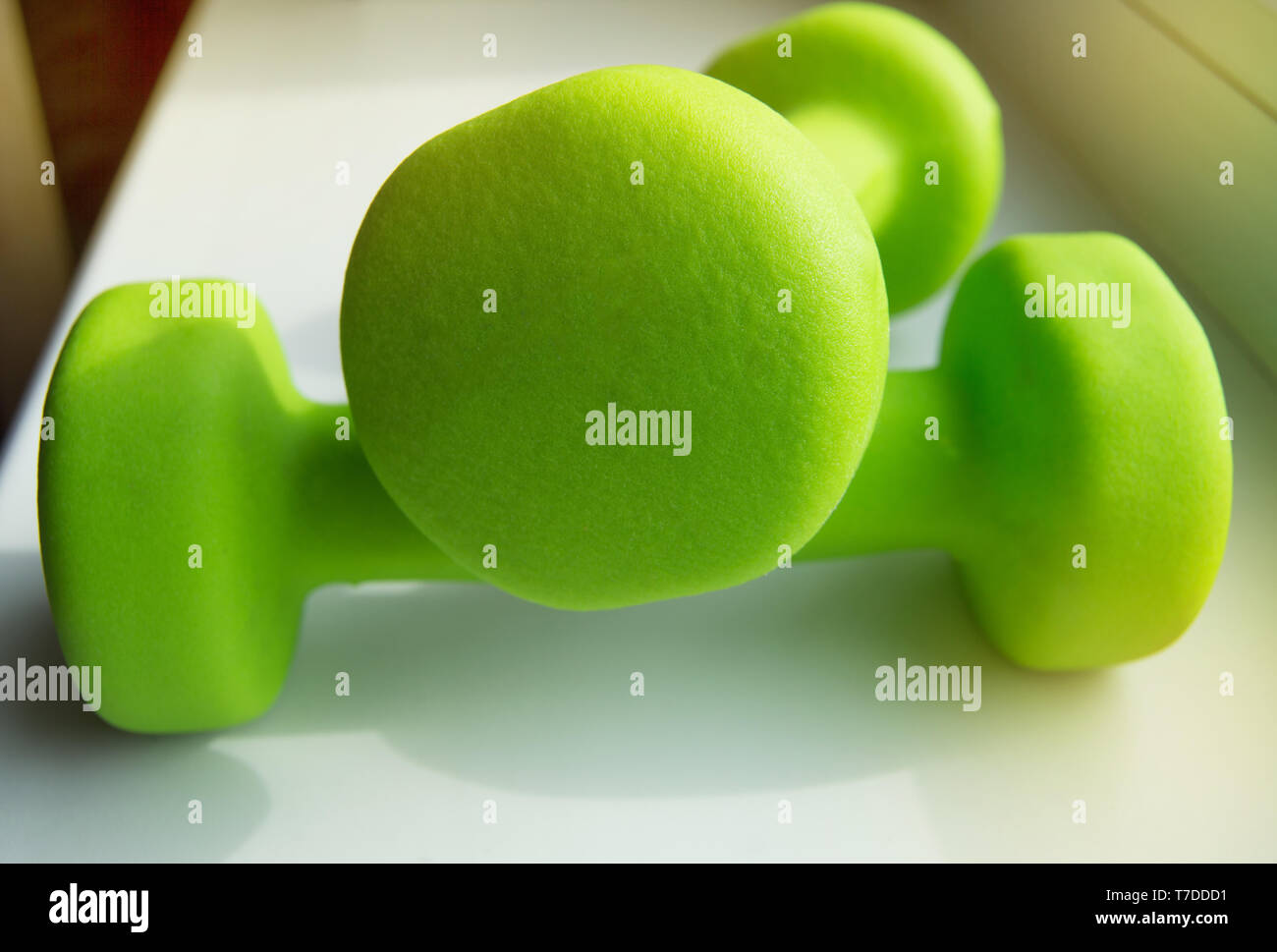 Concept of fitness, healthy lifestyle-two green dumbbells for sports ...