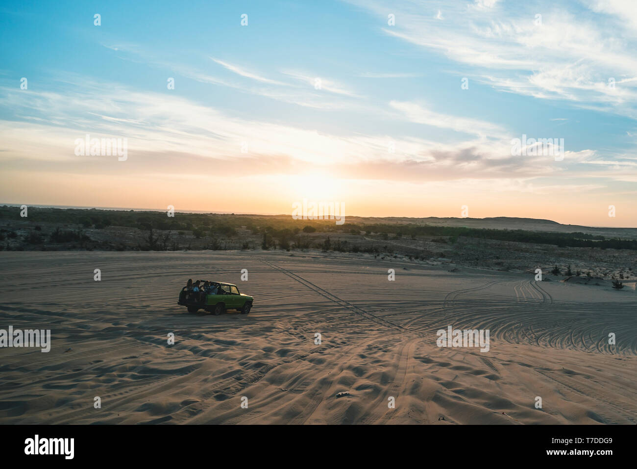 Desert safari with off road 4x4 car in sunlight. colorful sunset in ...