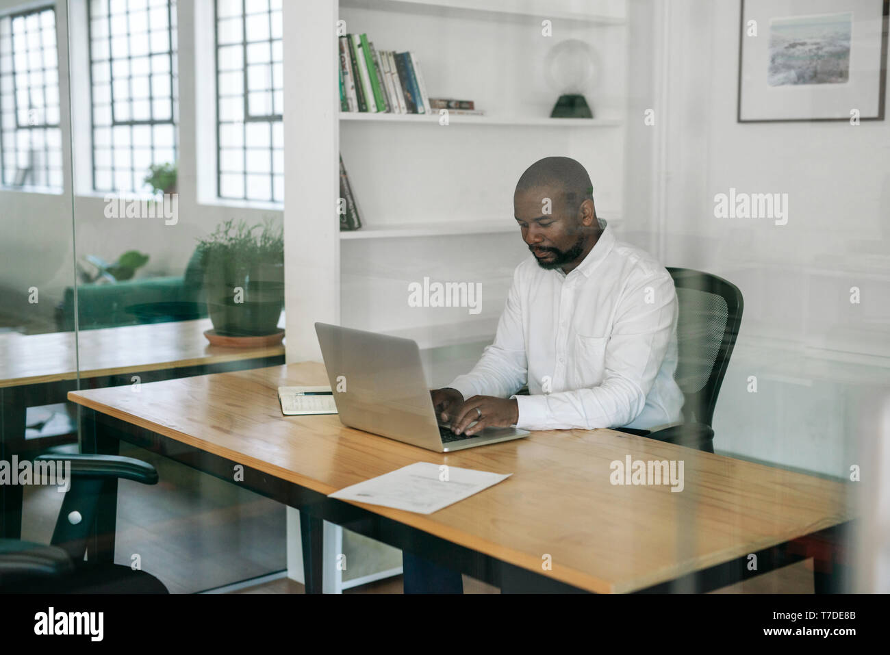 Manager working on a laptop at his office desk Stock Photo - Alamy