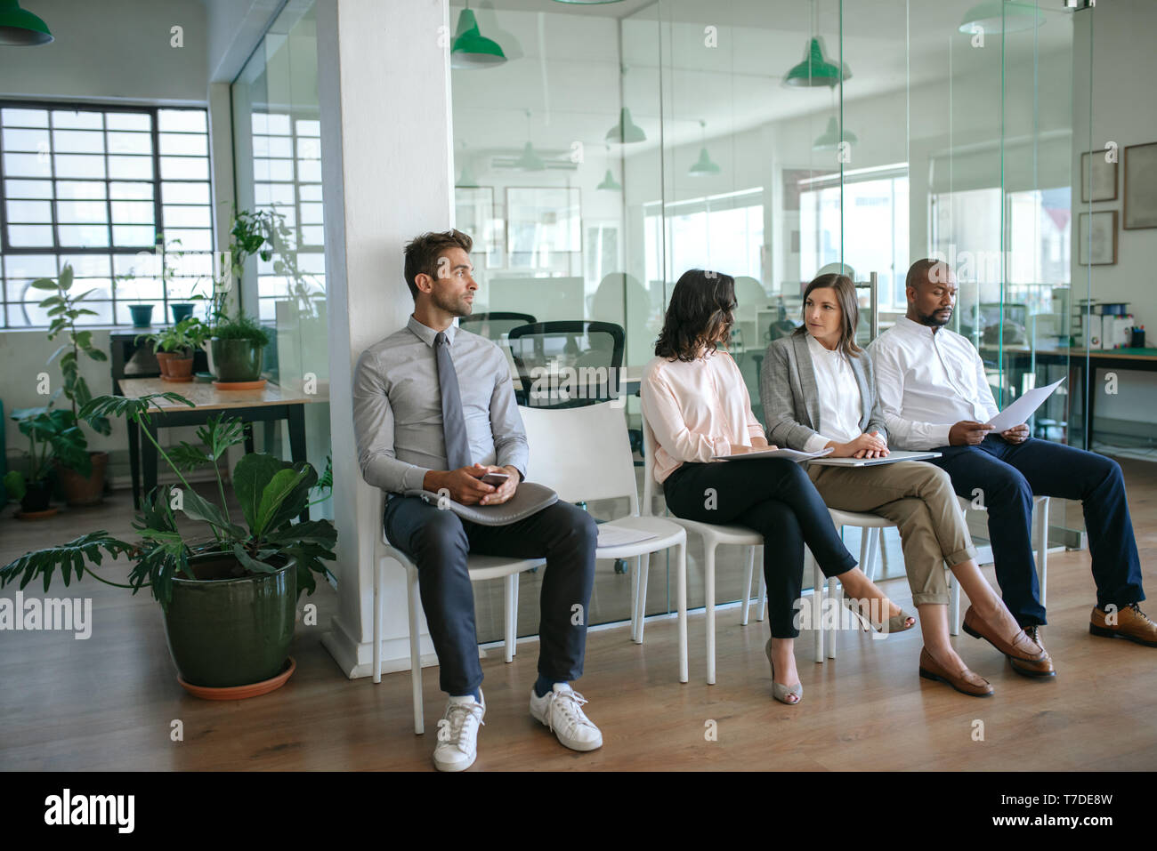 People sitting together in an office waiting for interviews Stock Photo ...