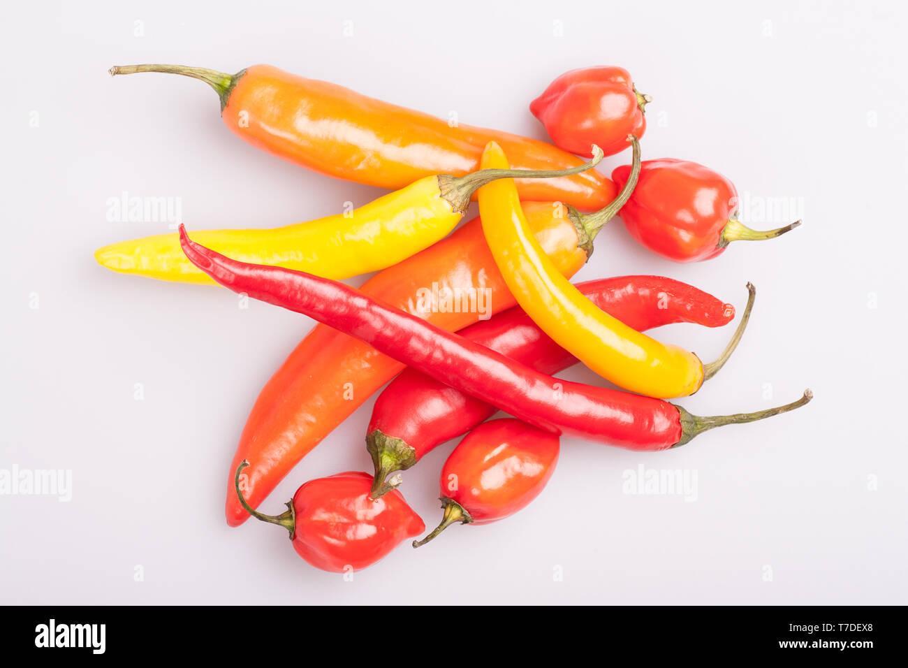 Heap of various chili peppers isolated on white background. Cooking ...