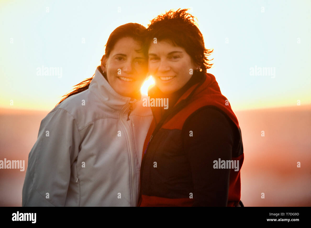 Two women standing next to each other hi-res stock photography and ...