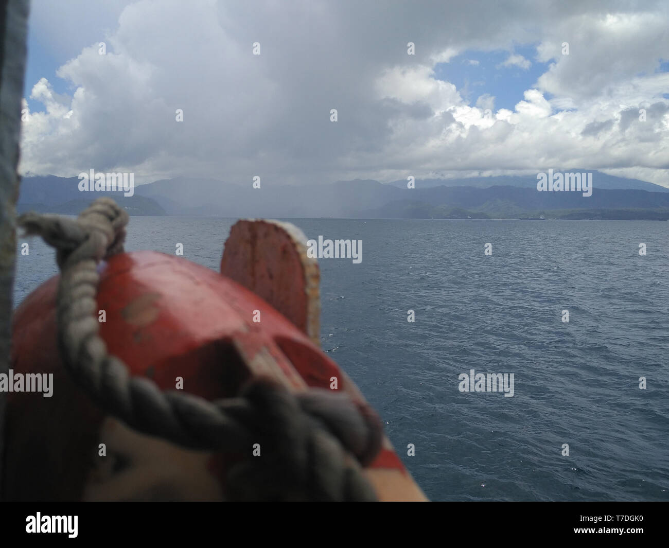 Rain clouds over water, with localised rain shower Stock Photo - Alamy