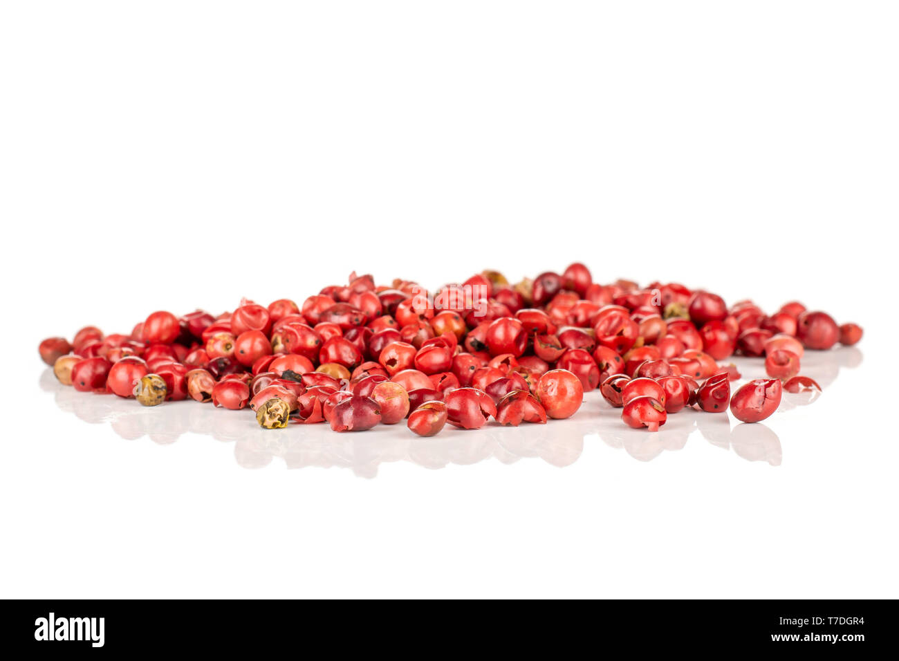 Lot of whole peruvian pink pepper heap isolated on white background ...