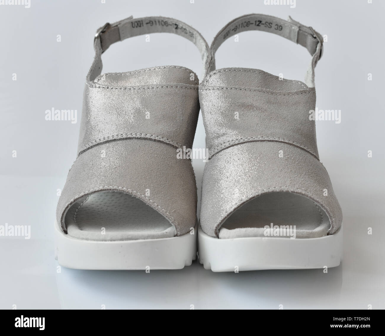 Gray summer female sandals on a white background Stock Photo - Alamy