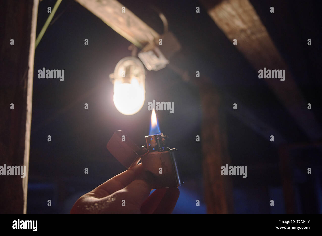 A zippo at the attic witch light and wooden bars Stock Photo - Alamy