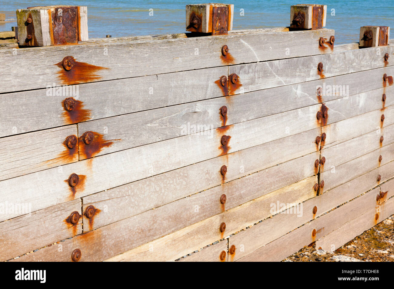 Wooden and concrete groynes, protect pebbly beach from erosion. St ...