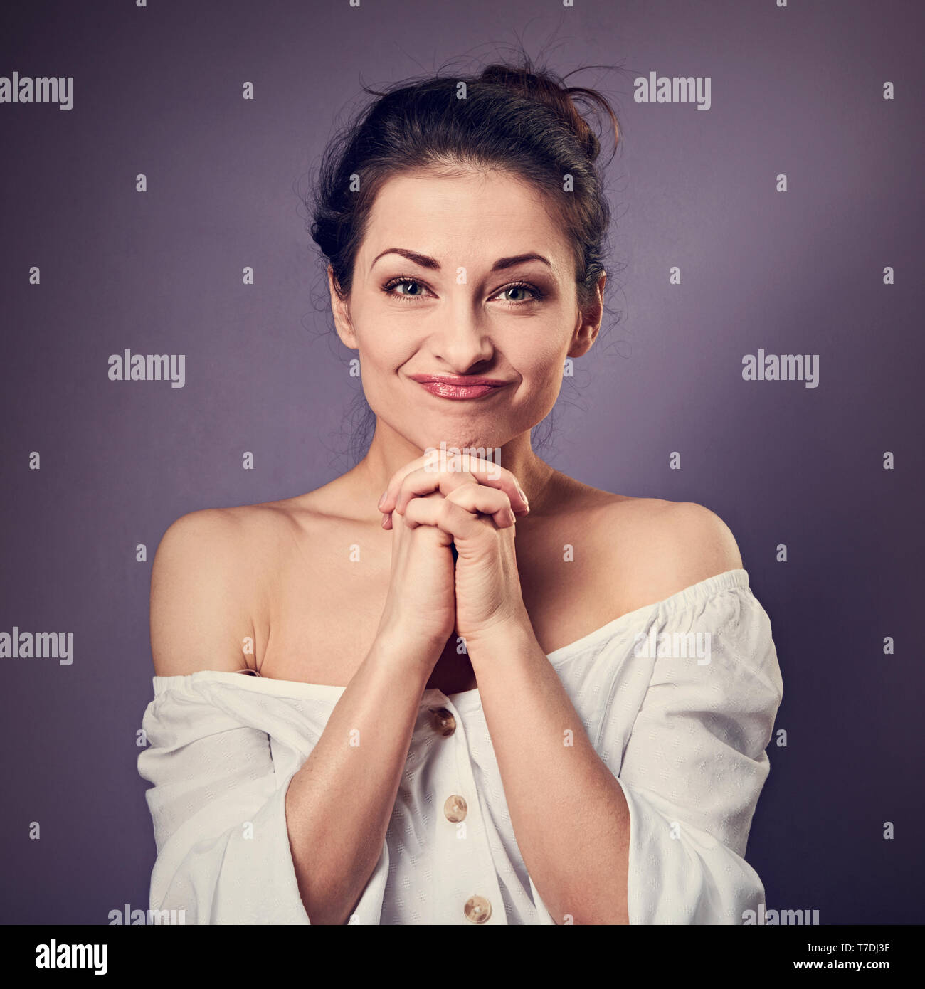 Beautiful excited fun grimacing woman in white shirt holding the hands ...