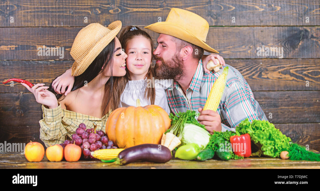 Grown with love. Family rustic style farmers at market with vegetables ...