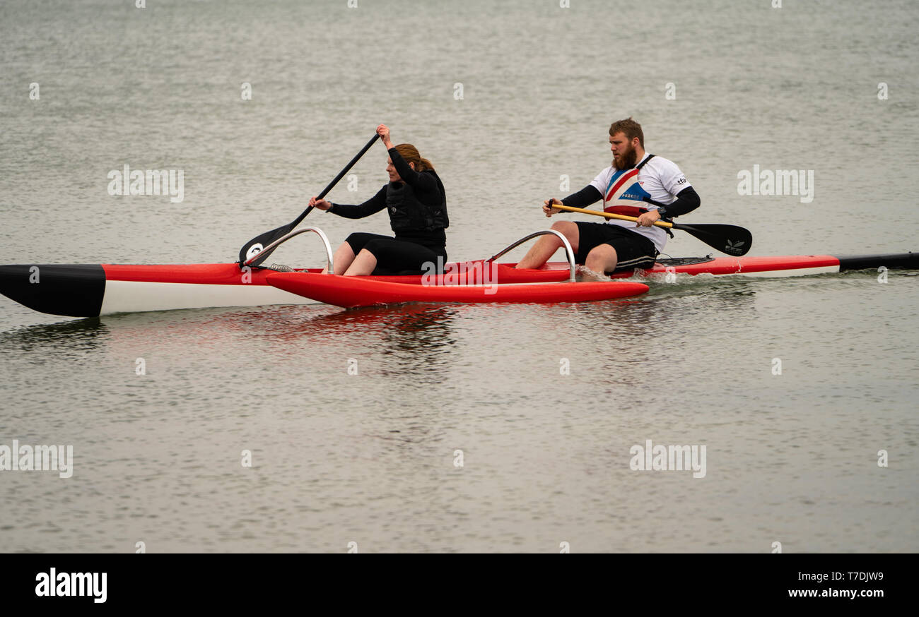 Mixed team (male/female) on OC2 / V2 small outrigger canoes on the sea ...