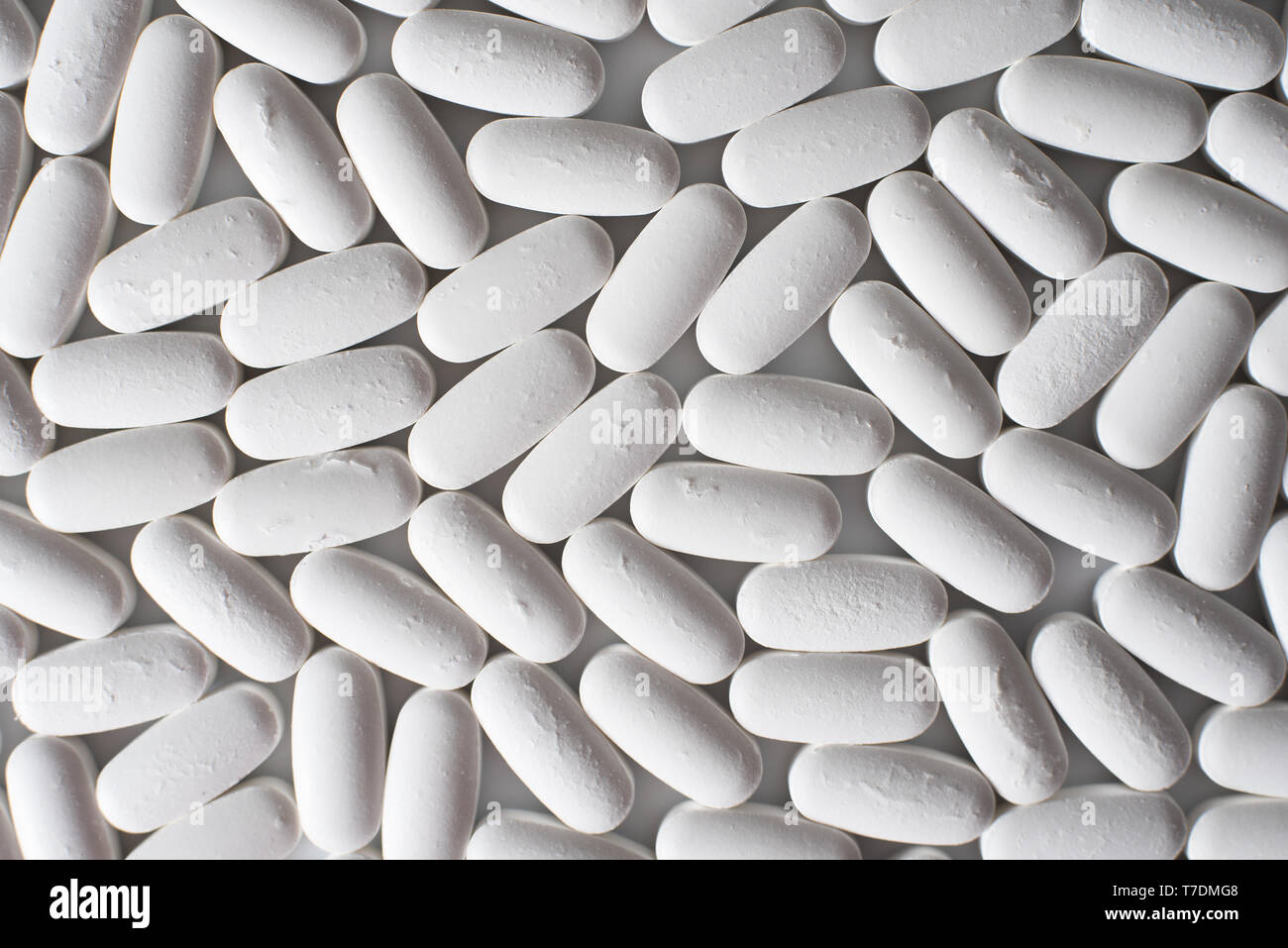 Detail of many white pills of medicines produced by the pharmaceutical ...
