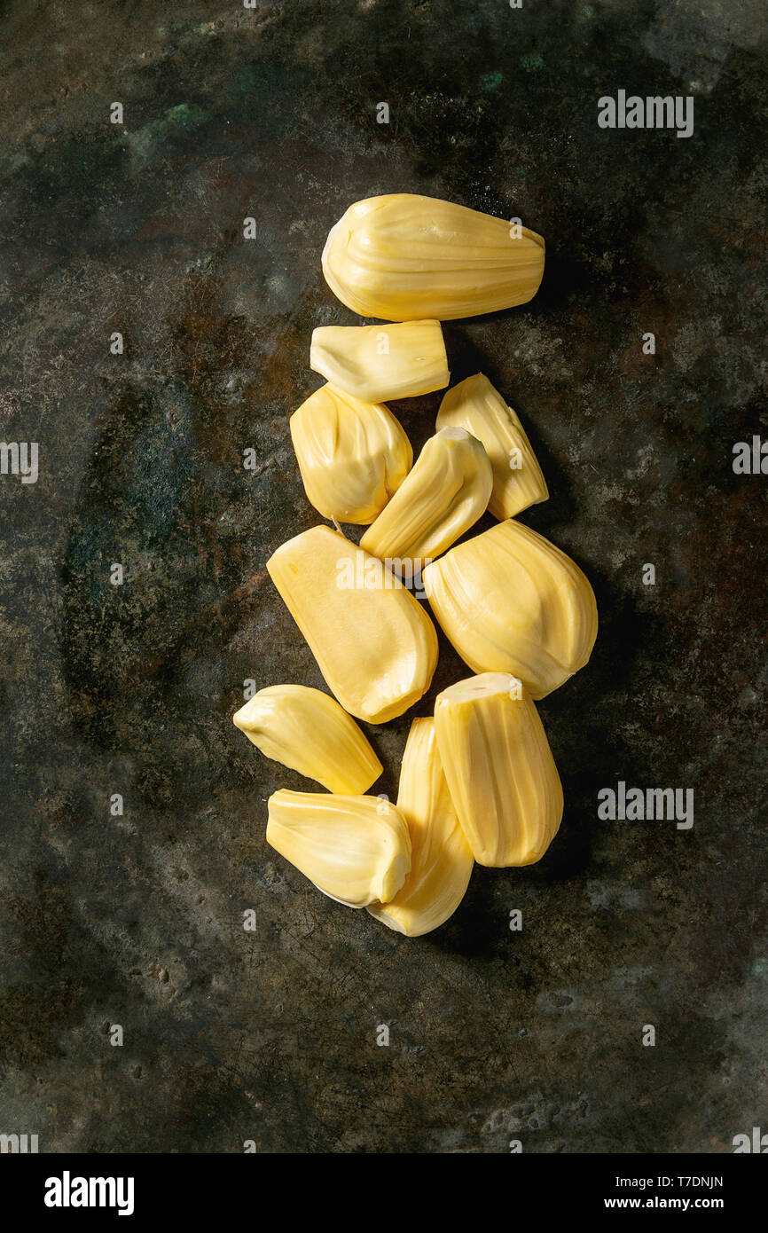Ripe raw peeled jackfruit over dark metal background. Flat lay, space ...