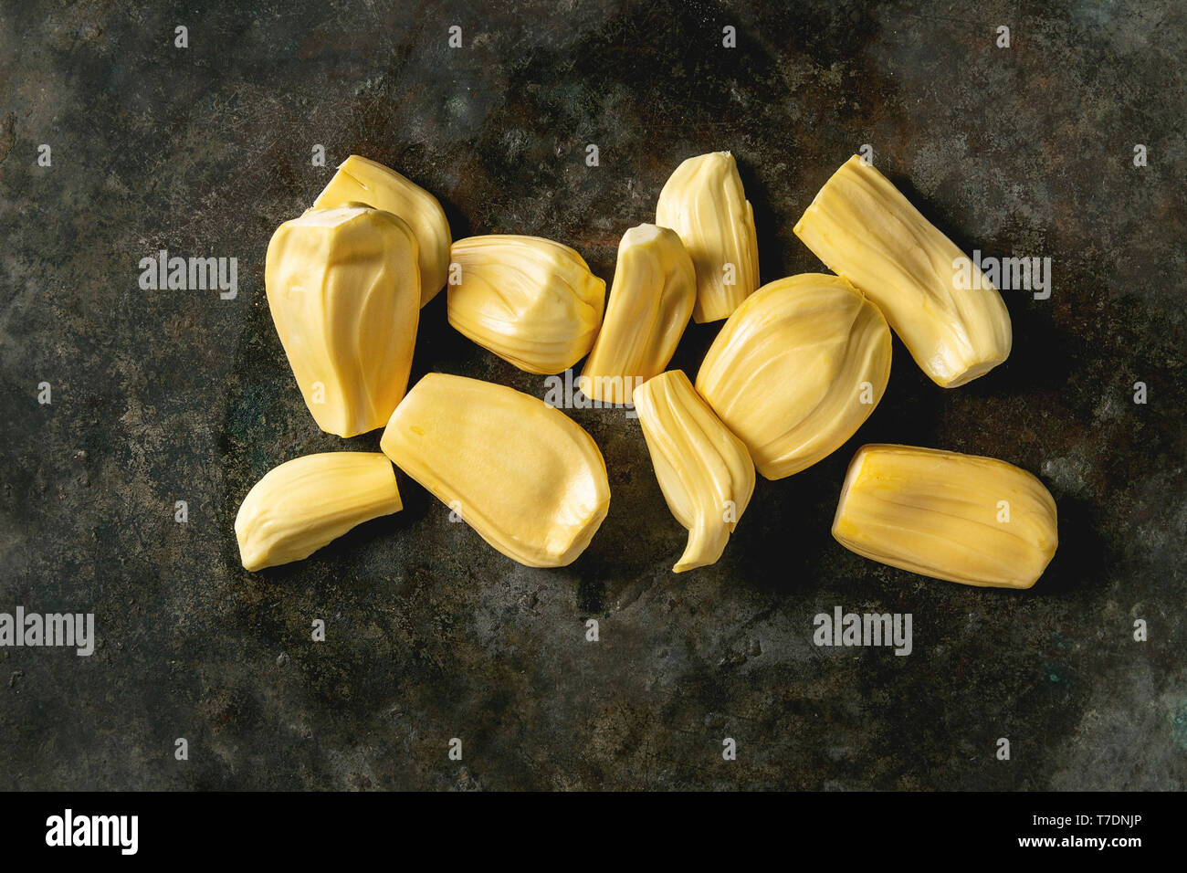 Ripe raw peeled jackfruit over dark metal background. Flat lay, space ...