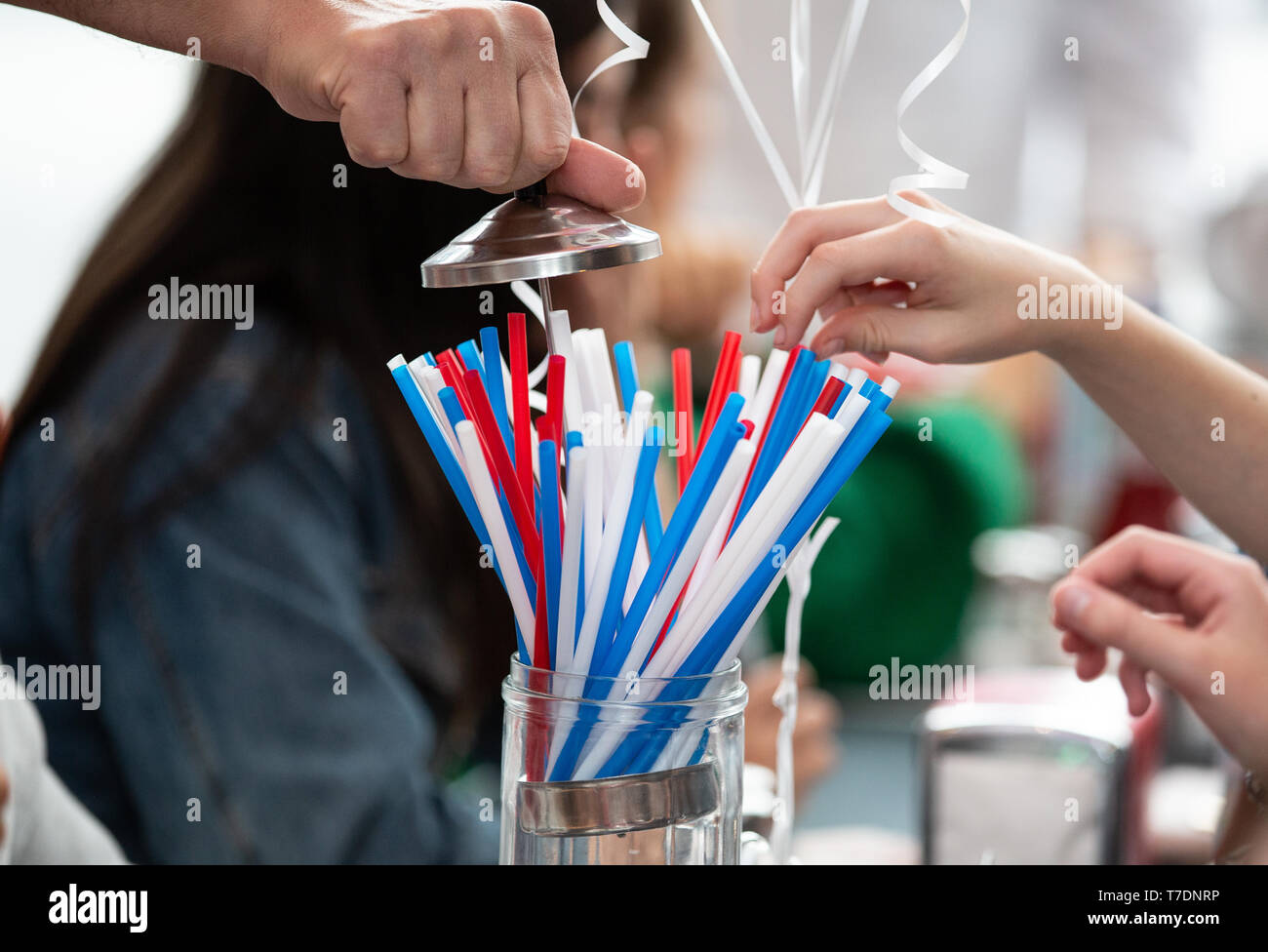 Child taking a plastic drinking straw in a fast food restaurant Stock ...