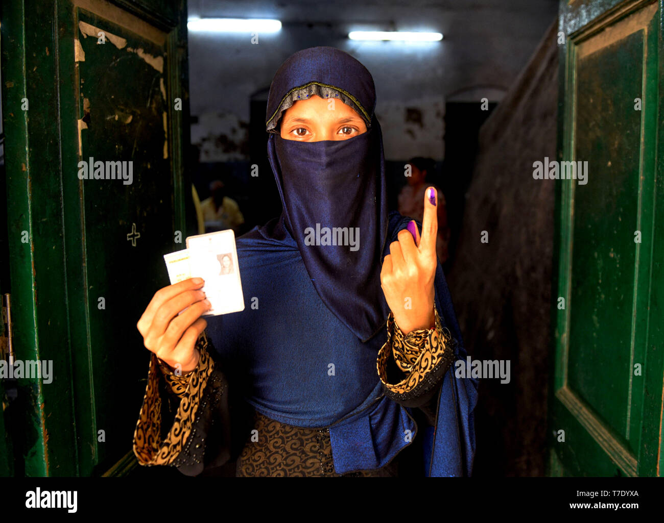 A Muslim girl seen showing her fingers with Ink as a symbol of polling ...