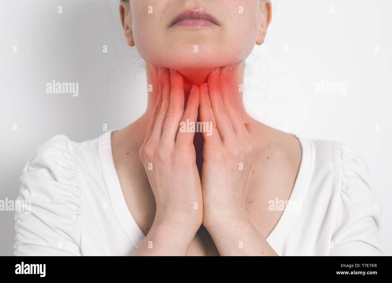 The girl is holding on to her sore throat. Angina. Inflammation of the ...