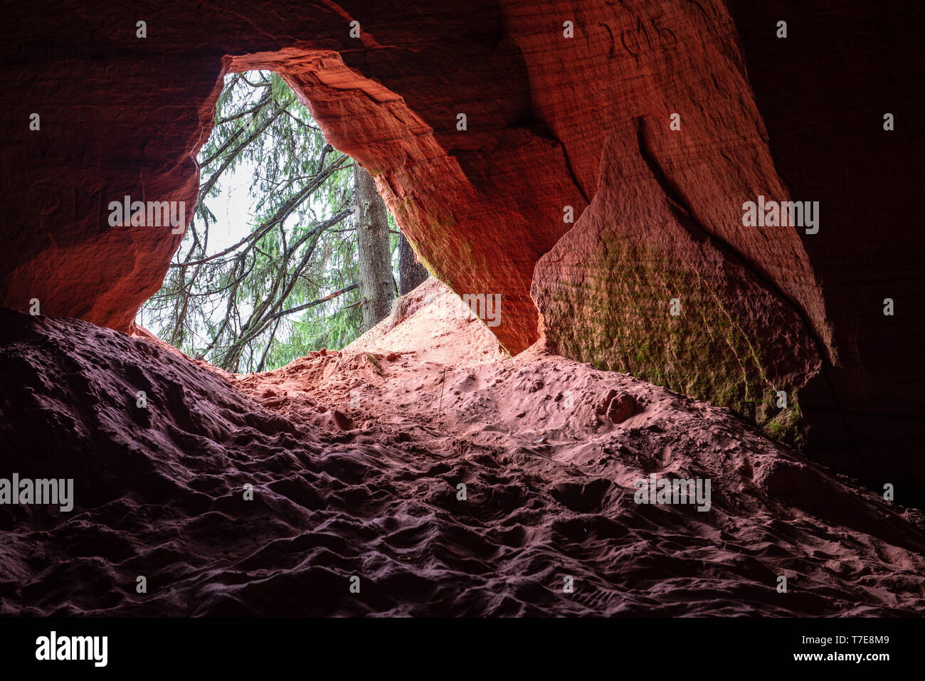 sandstone cave entrance in dark. sand covered ground. latvia Stock ...