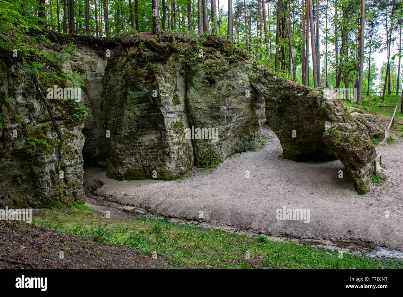 sandstone cave entrance in dark. sand covered ground. latvia Stock ...