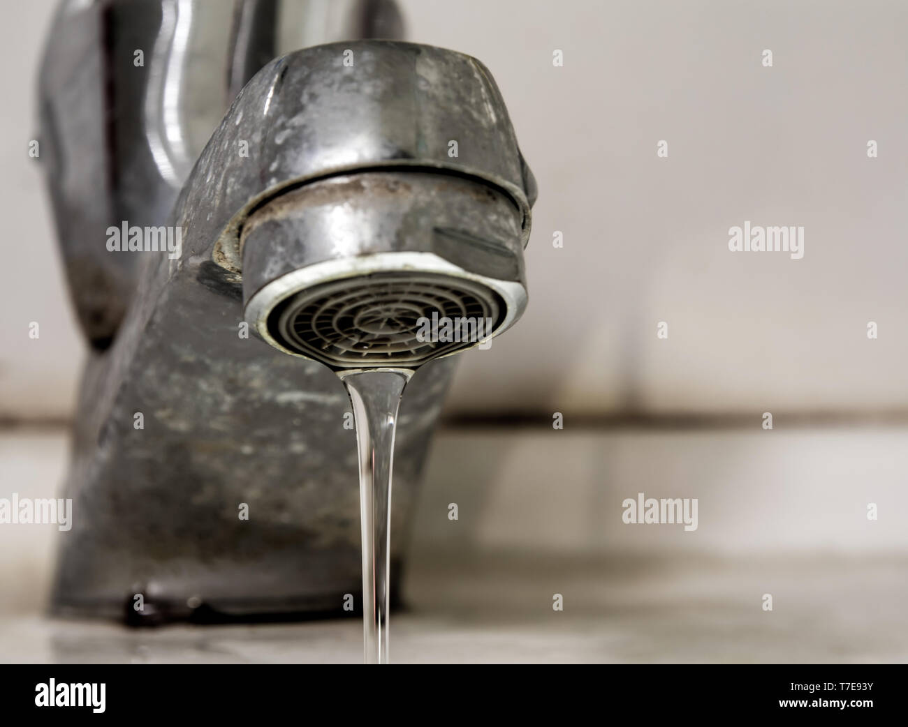 Leaking water drops from old rust and stained faucet, Save water ...