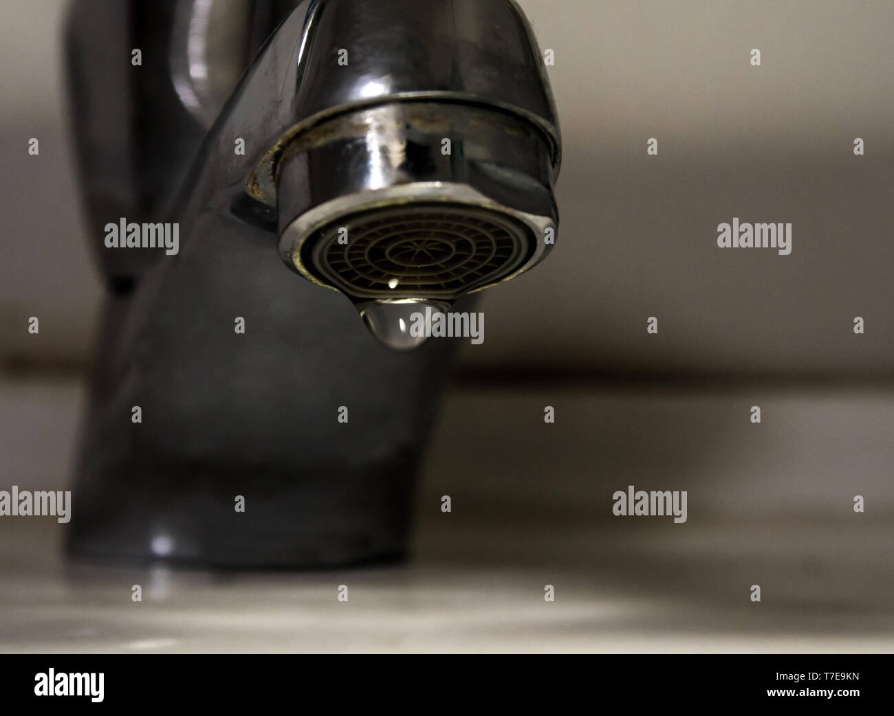 Leaking water drops from old rust and stained faucet, Save water ...