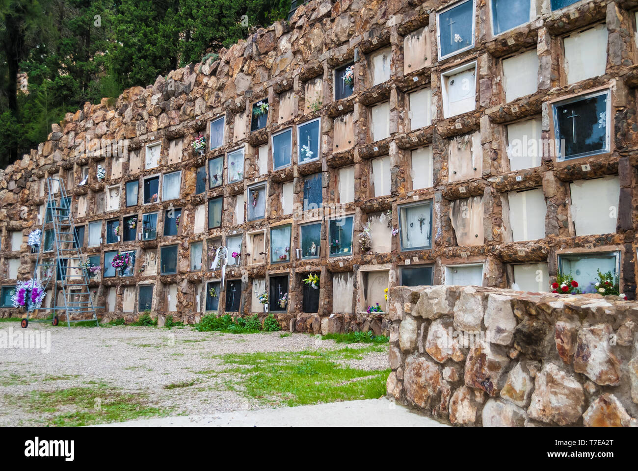 The stone wall with many graves on the Montjuic Cemetery, Barcelona ...