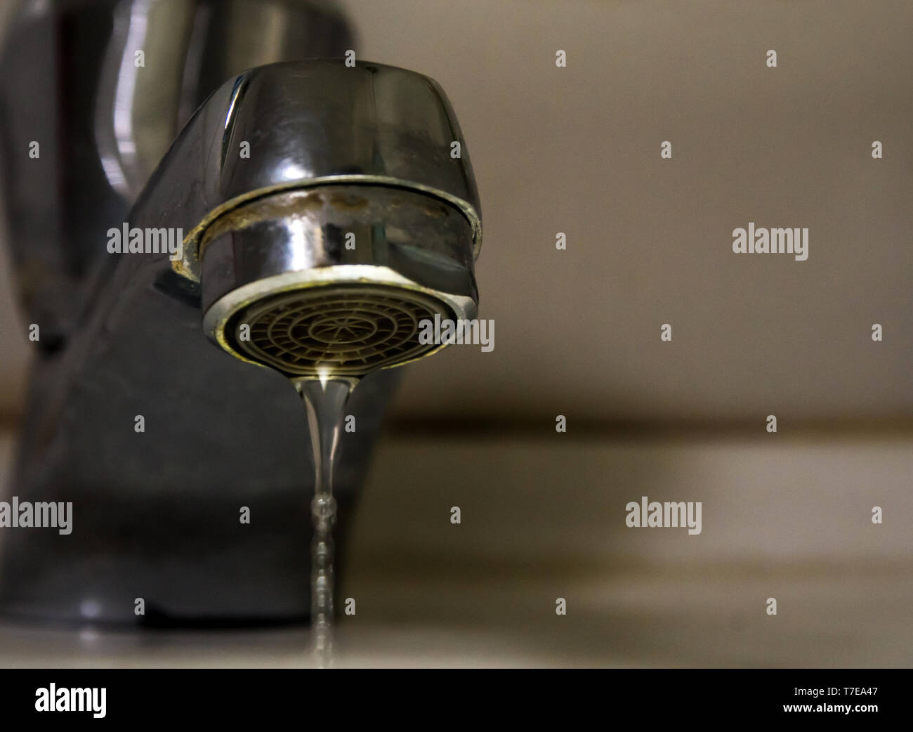 Leaking water drops from old rust and stained faucet, Save water ...