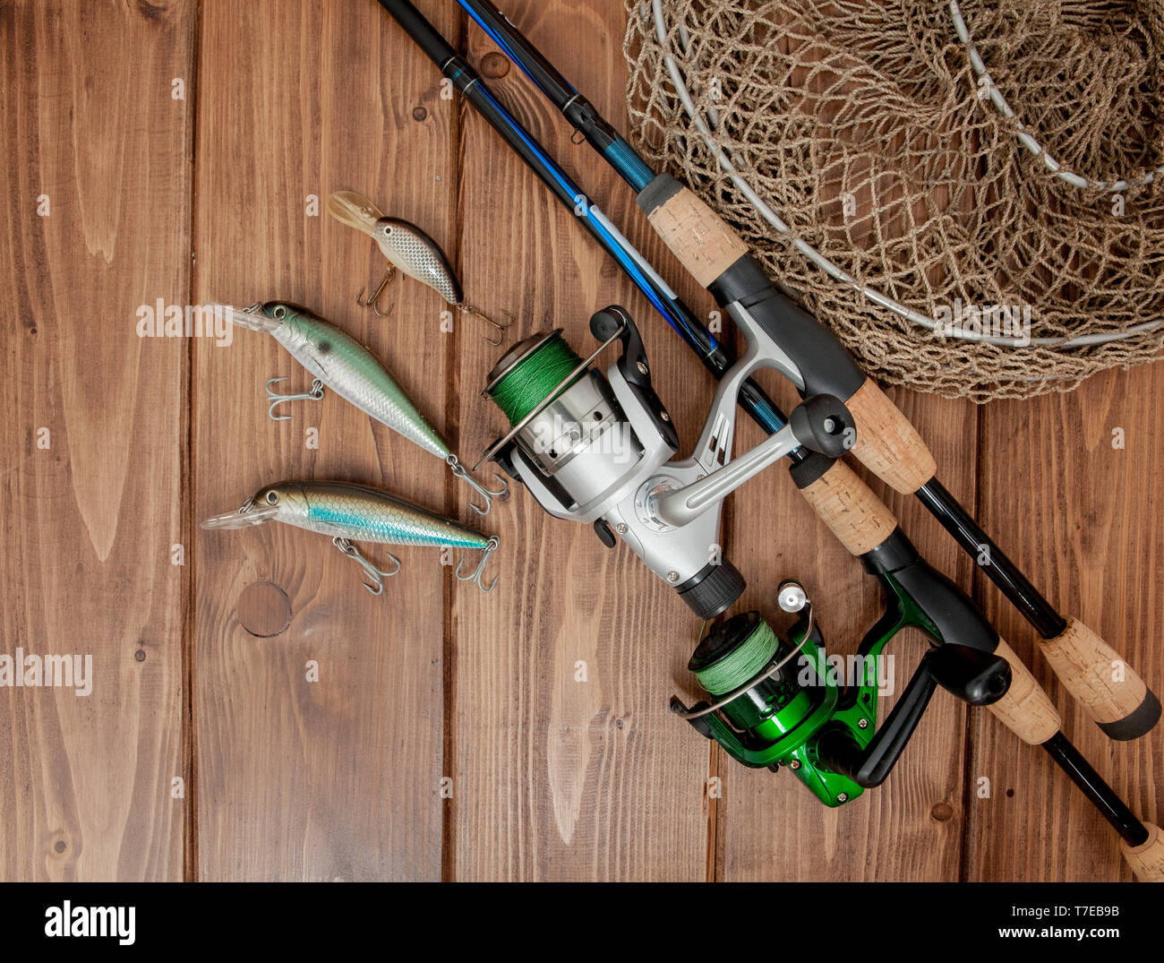 Fishing tackle - fishing spinning, hooks and lures on wooden background ...