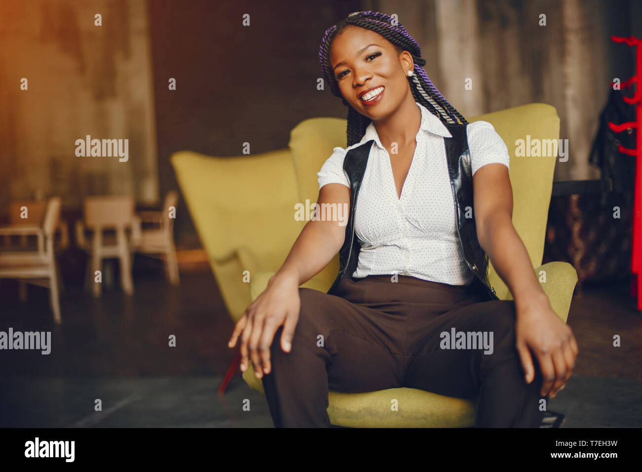 A stylish and beautiful dark-skinned girl sits in a cafe Stock Photo ...