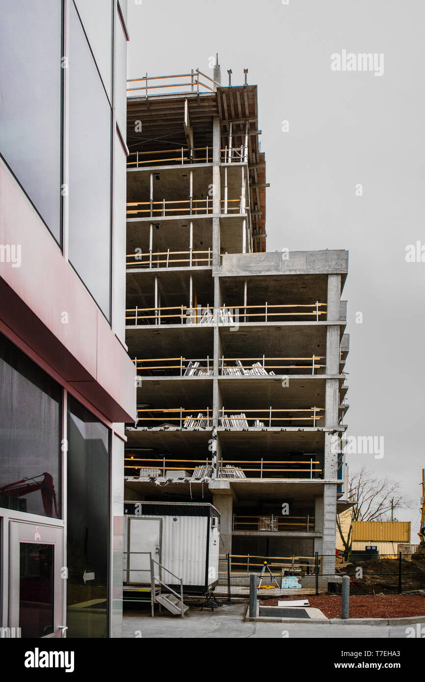 A multi-story building under construction, in a modern neighborhood ...