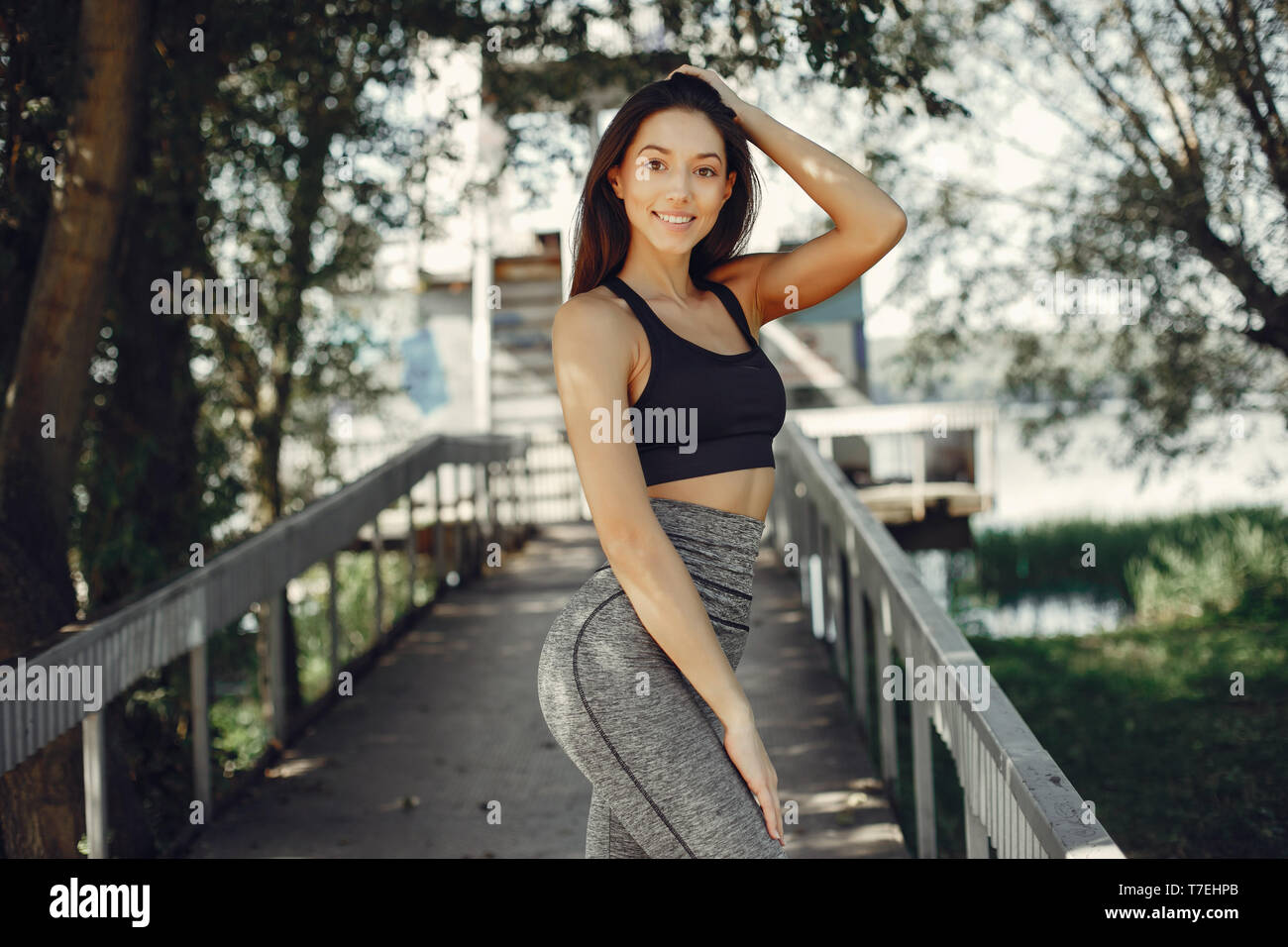 Beautiful girl in a park. Stylish girl in a sport clothes Stock Photo ...