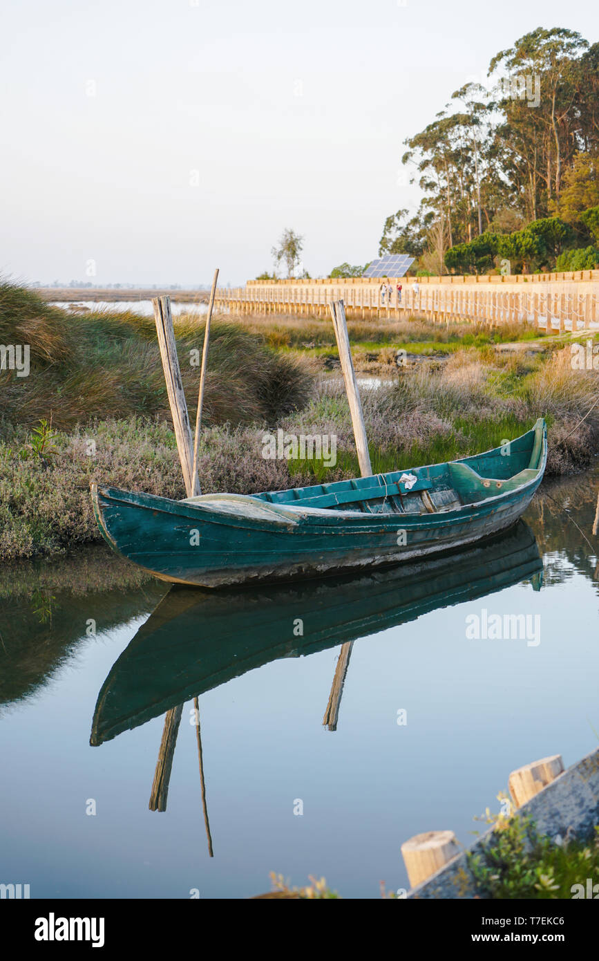 Quaint small boat next to shore in peaceful lagoon on bright day. Boat ...