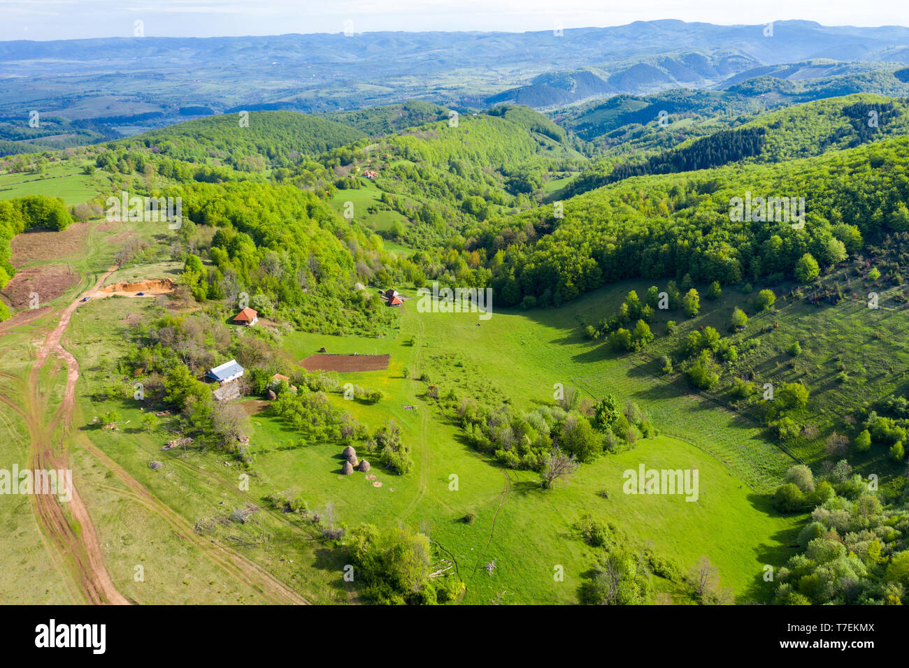 Aerial view of a countryside homestead houses in the mountains by drone ...