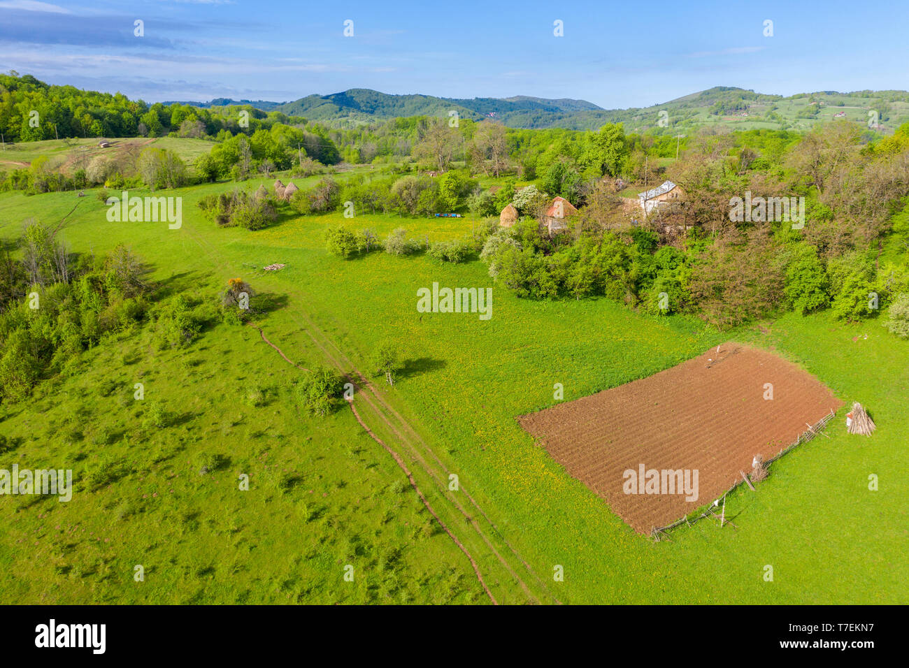 Aerial view of a countryside homestead houses in the mountains by drone ...