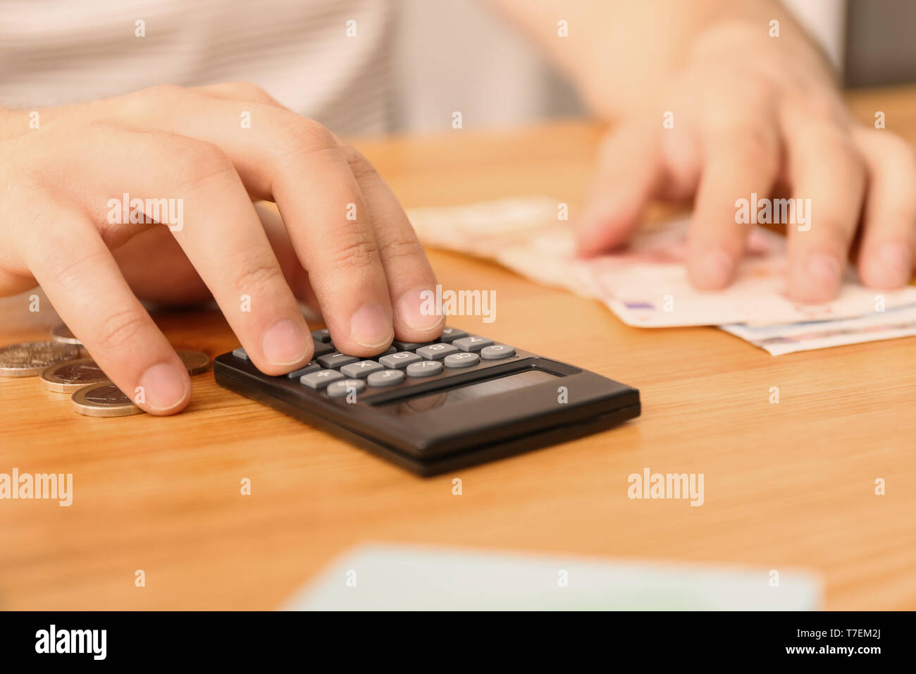 Young businessman counting coins hi-res stock photography and images ...