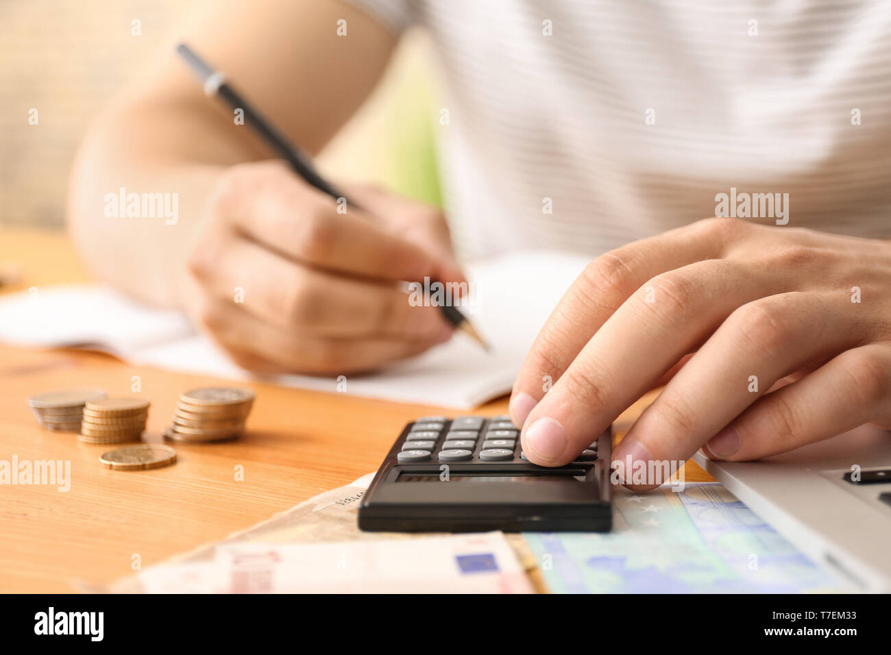 Young businessman counting coins hi-res stock photography and images ...