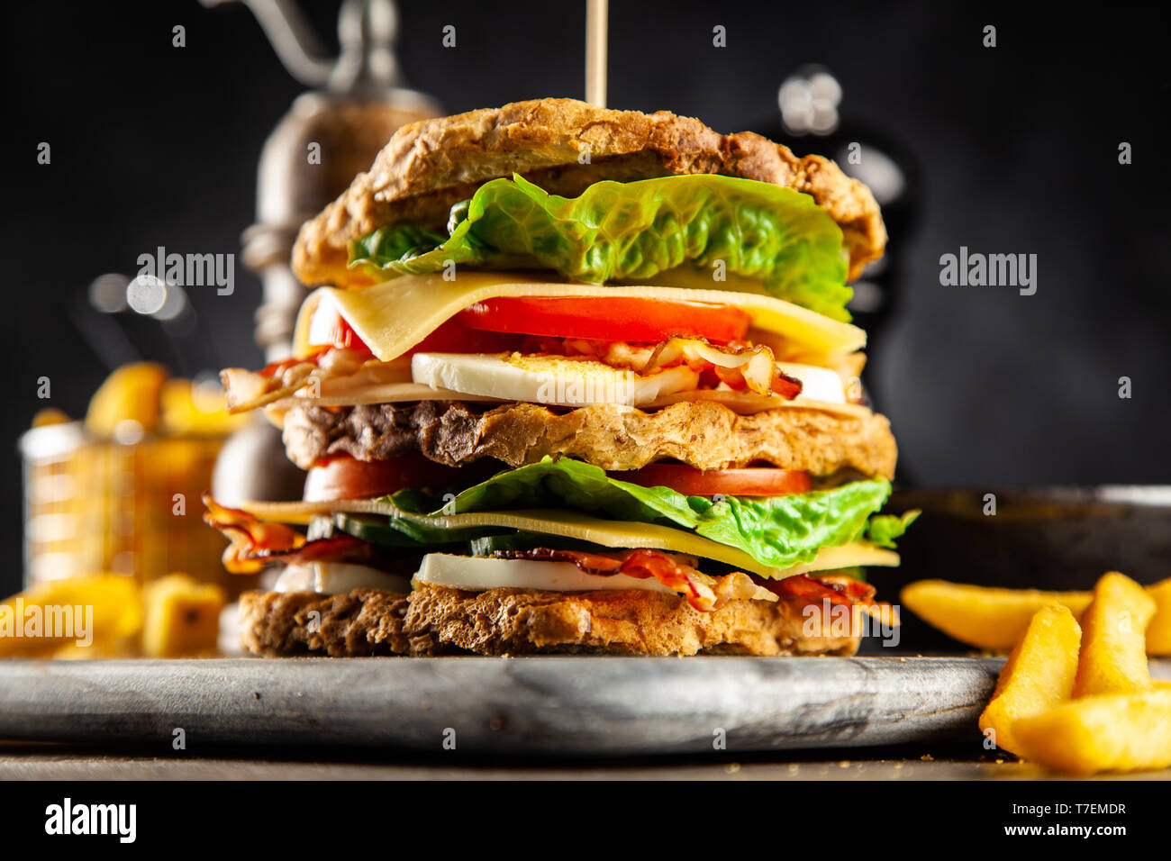 Tall club sandwich and french fries Stock Photo - Alamy