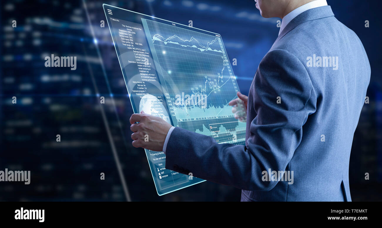 Businessman holding a modern tablet touch screen analysing on ...