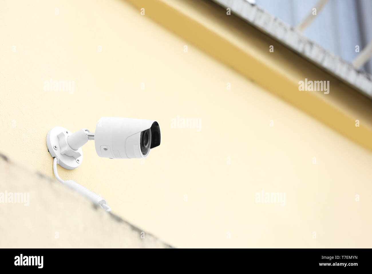 Modern CCTV camera installed on wall of building outdoors Stock Photo ...
