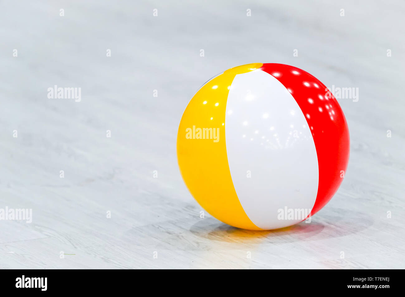 rubber beach yellow white red ball lay on the gray wood floor Stock ...