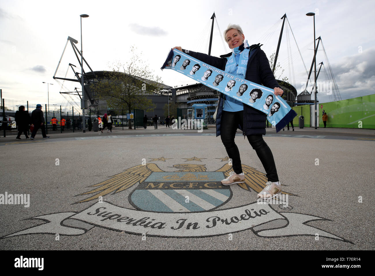 A Manchester City fan poses for a picture at the Etihad Stadium ...
