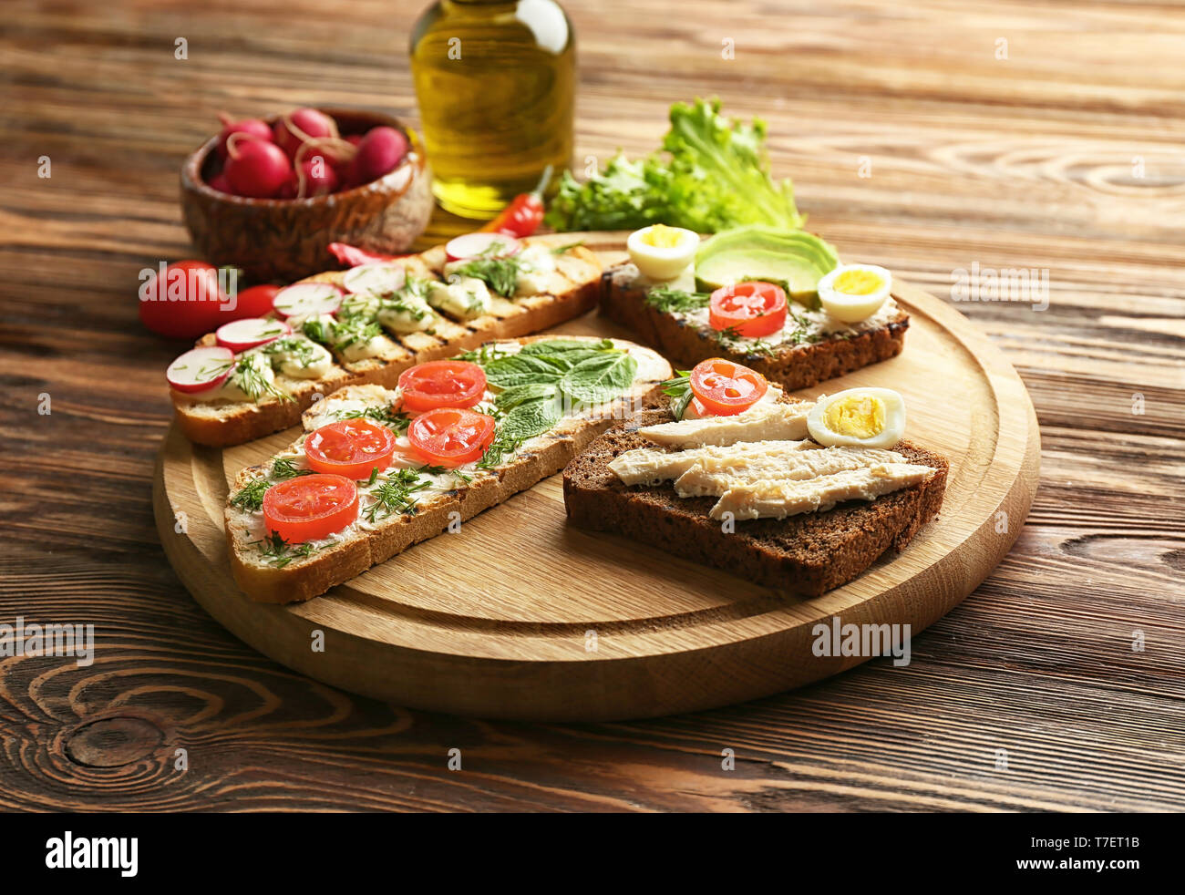 Delicious toasts on wooden table Stock Photo - Alamy