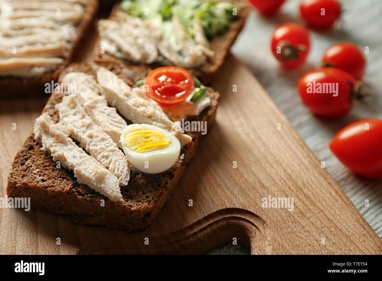 Delicious toast with meat and egg on board, closeup Stock Photo - Alamy