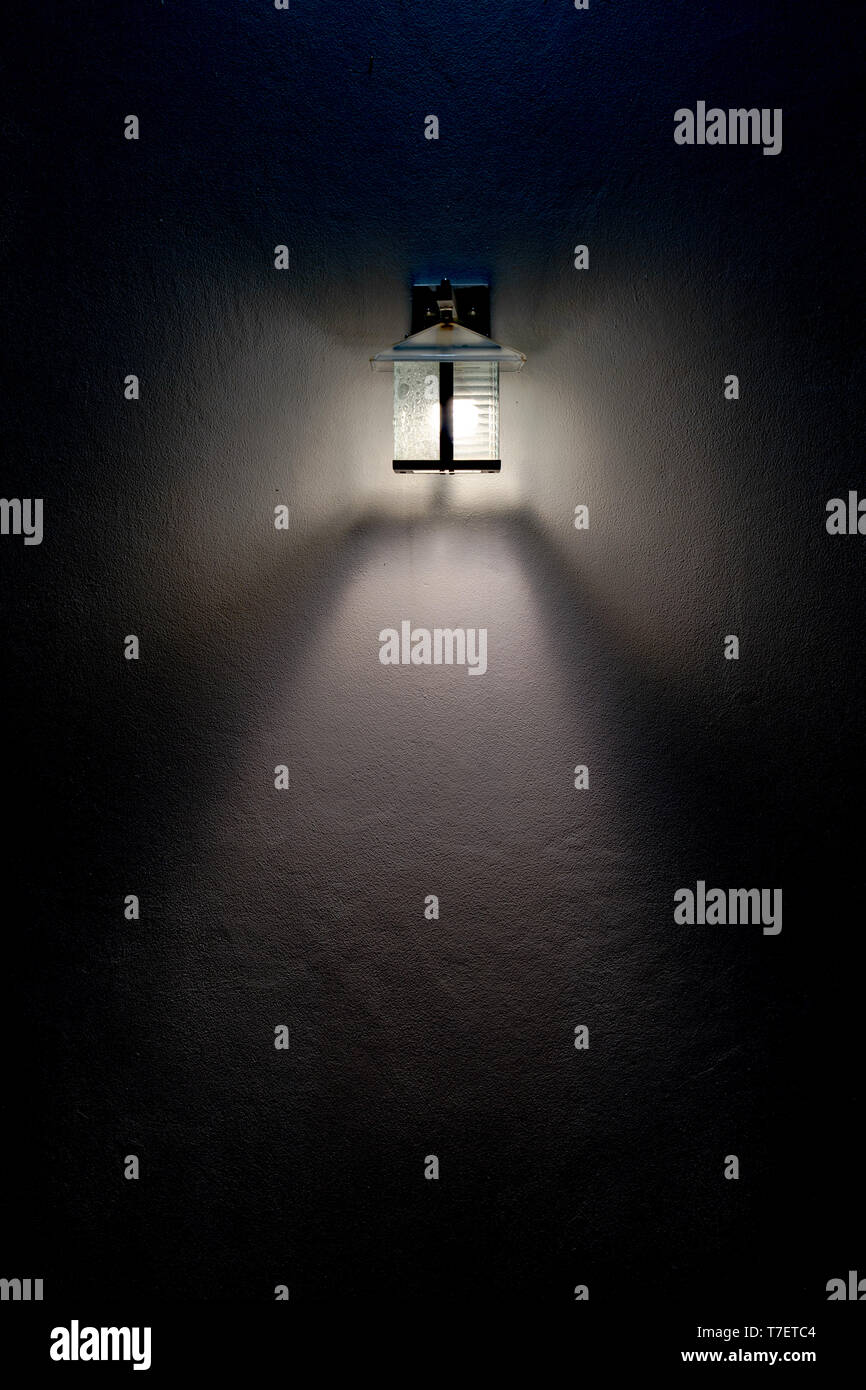 Square glass lamp LED beam light on the white wall in the dark Stock ...