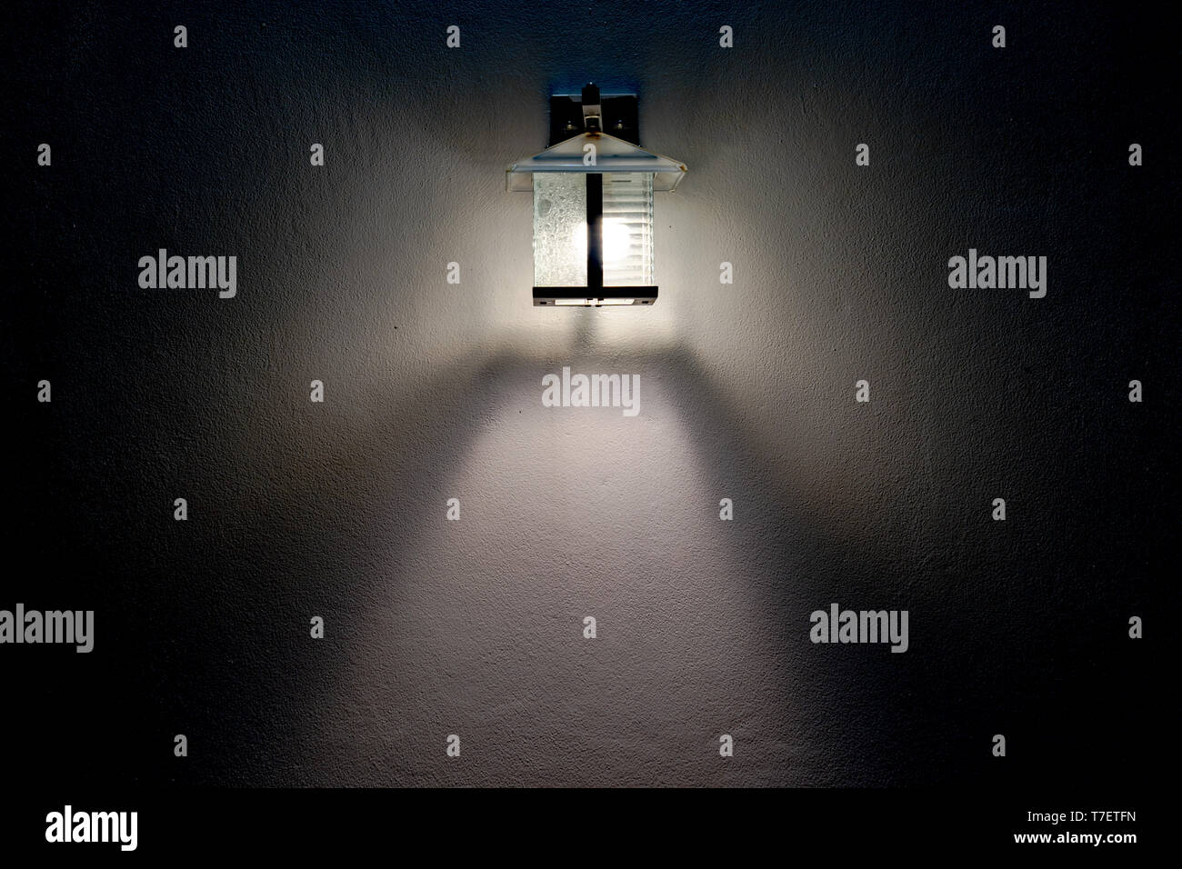 Square glass lamp LED beam light on the white wall in the dark Stock ...