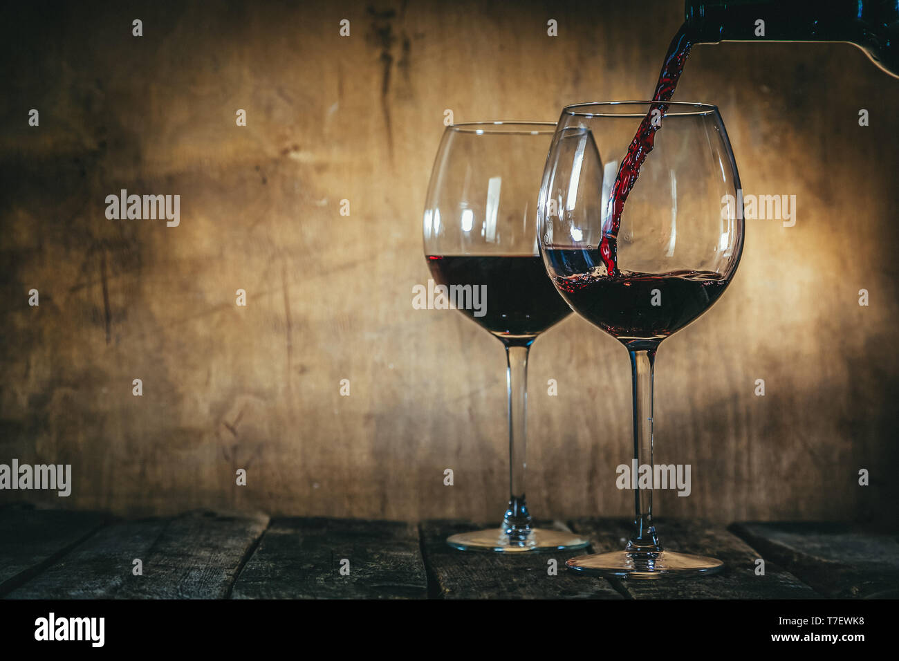 Red wine in glasses on rustic background Stock Photo - Alamy