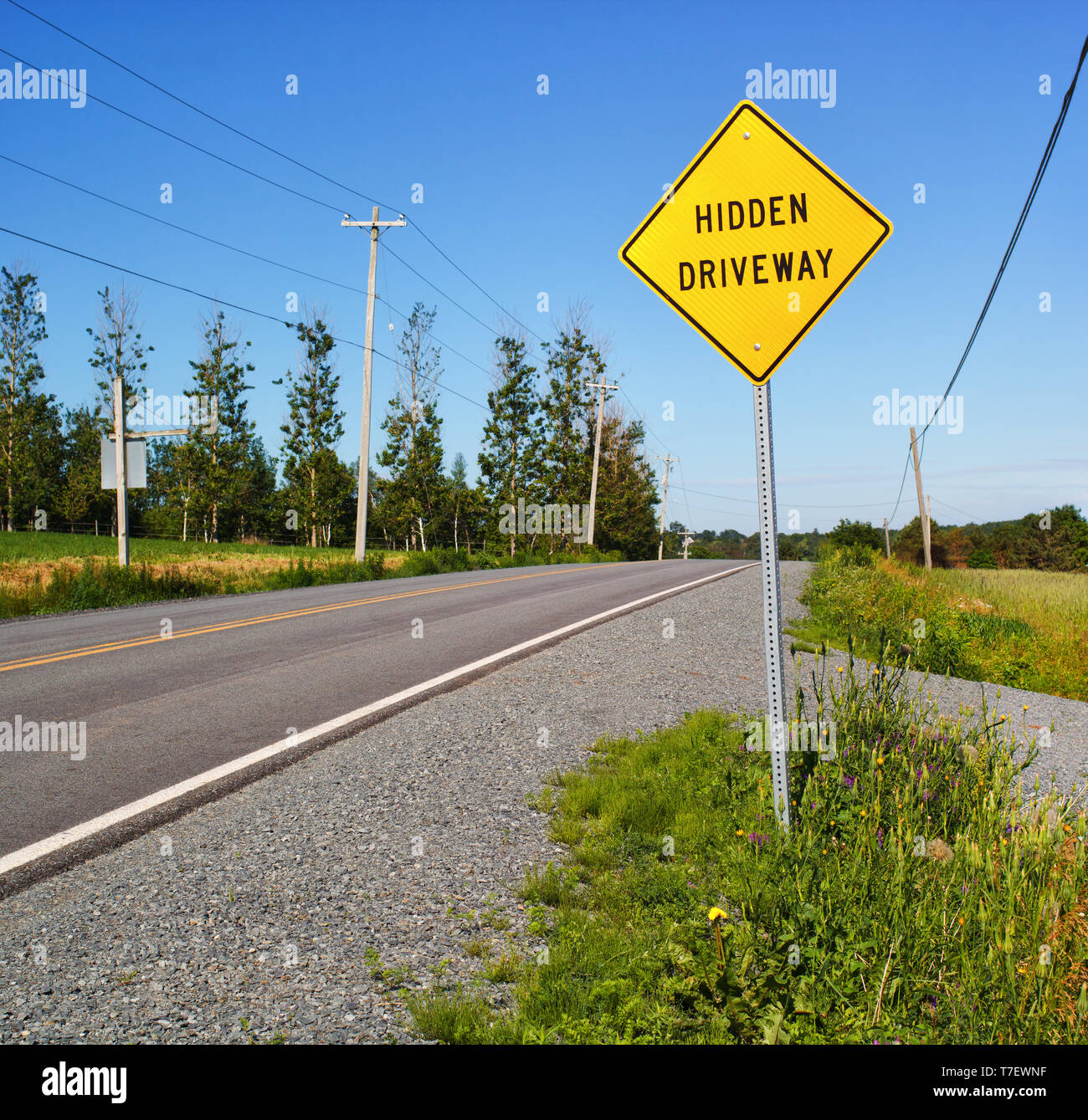 Hidden driveway sign on rural highway Stock Photo - Alamy