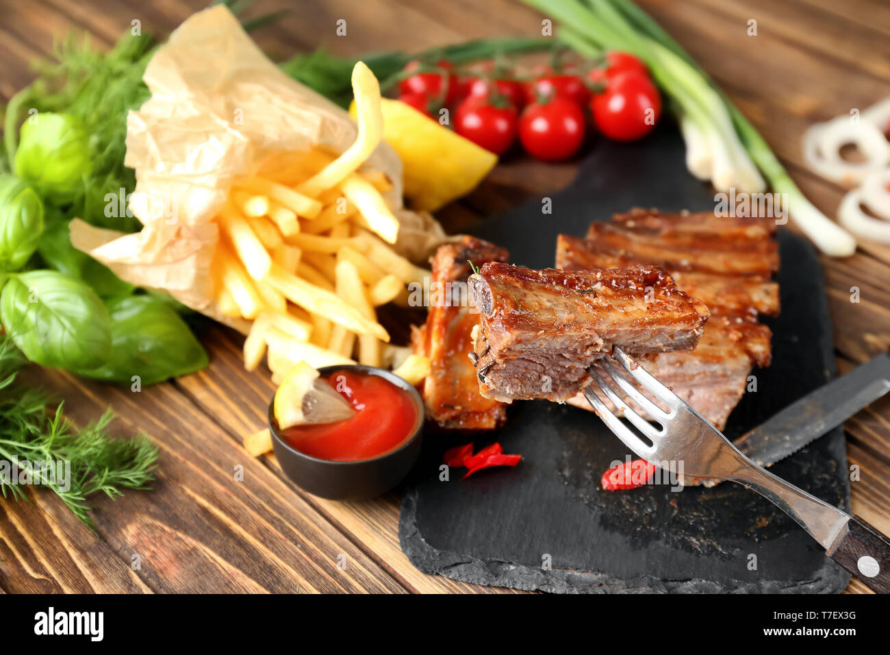 Eating of delicious grilled ribs Stock Photo - Alamy